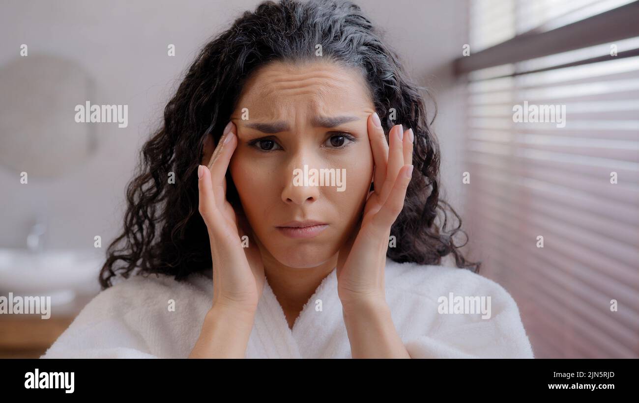 Headshot worried frustrated young woman looking in mirror in bathroom ...