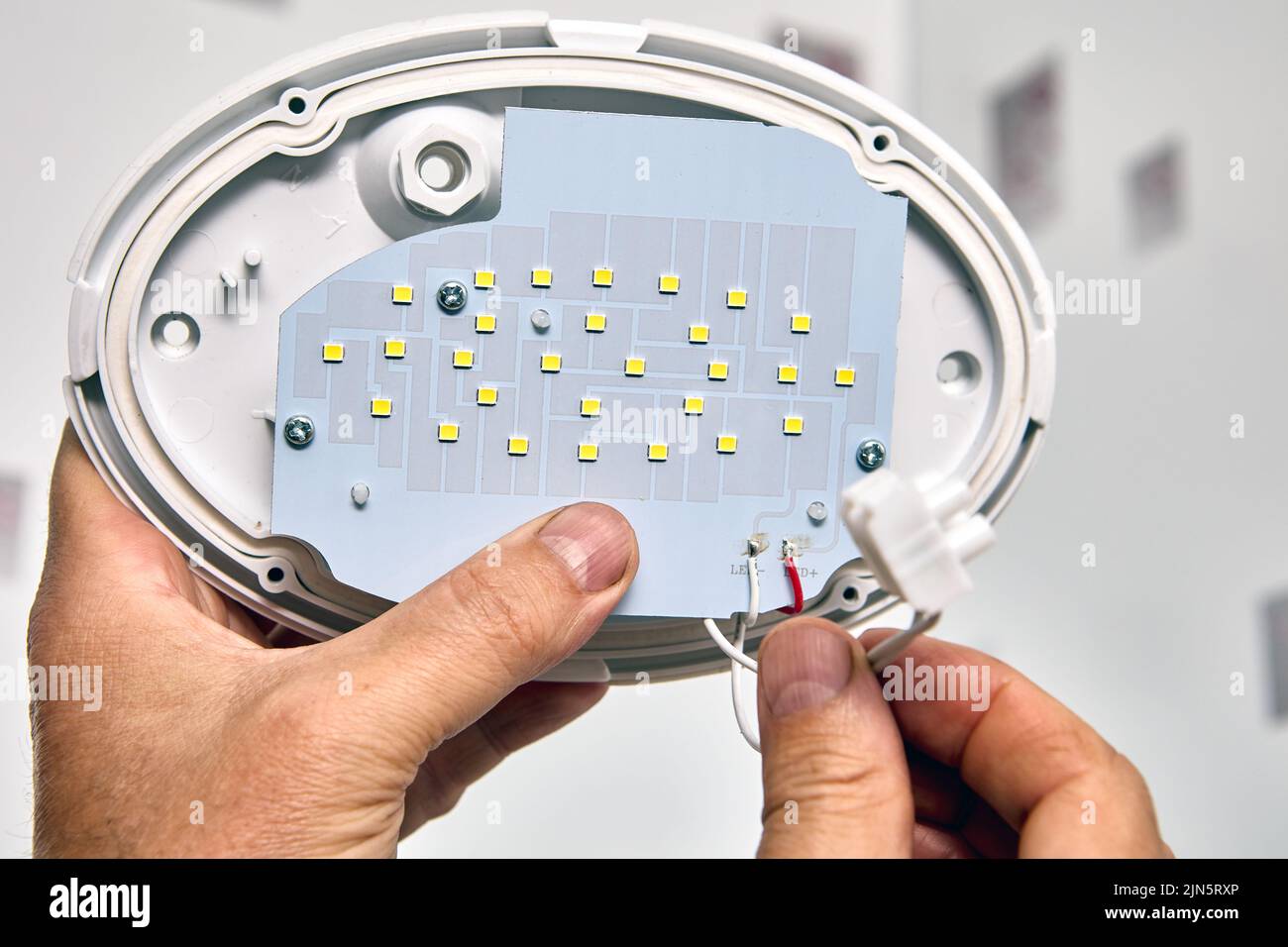 LED wall light panel, electrician connect wires Stock Photo - Alamy