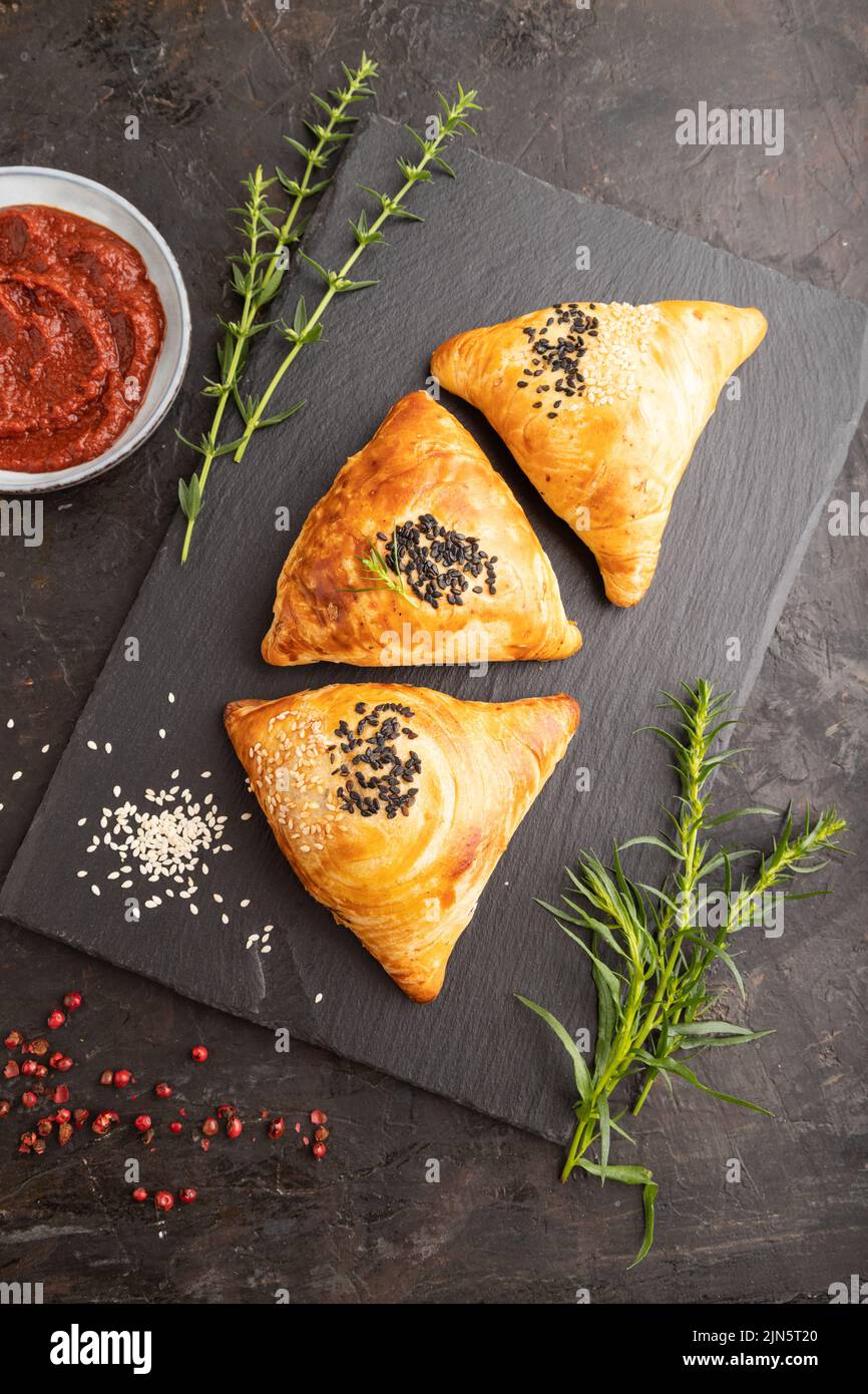 Homemade asian pastry samosa on black concrete background. top view ...