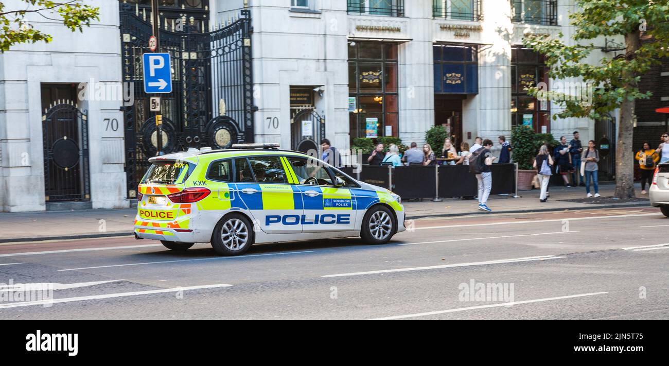 A marked Metroploitan Police car speeds through the streets of London ...