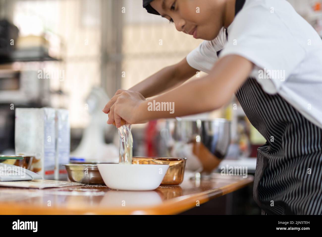 Happy boy cracking an egg for baking a cake in kitchen Stock Photo - Alamy