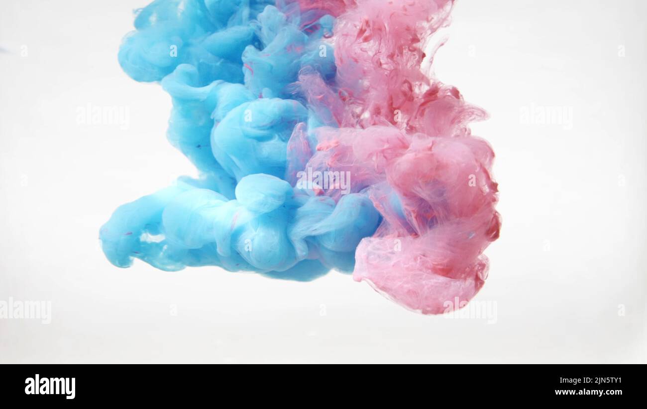 The pink and blue ink spreading in water on white background Stock Photo - Alamy