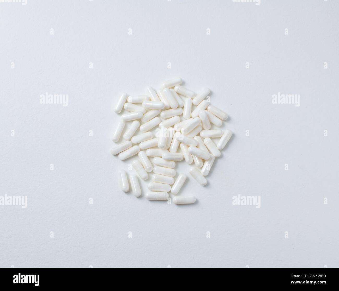 Pile of pill on white table. Top view of pile white pill painkiller ...