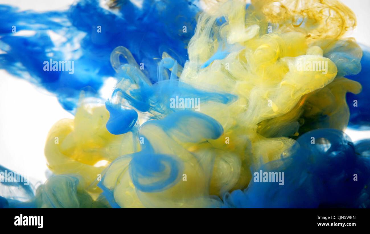 The colorful ink spreading in water on white background Stock Photo - Alamy