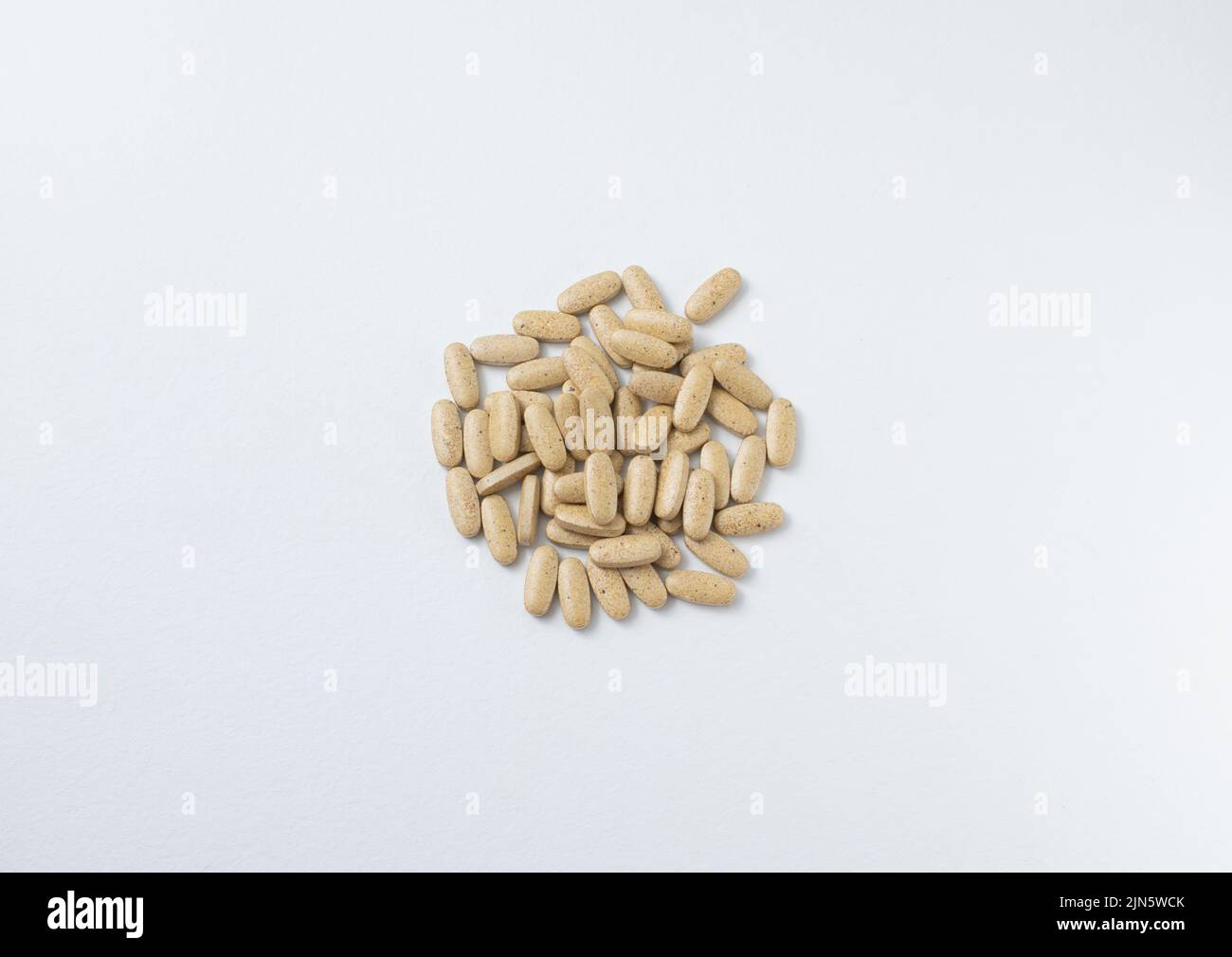 Brown pills, medicine isolated on white background, top view ...