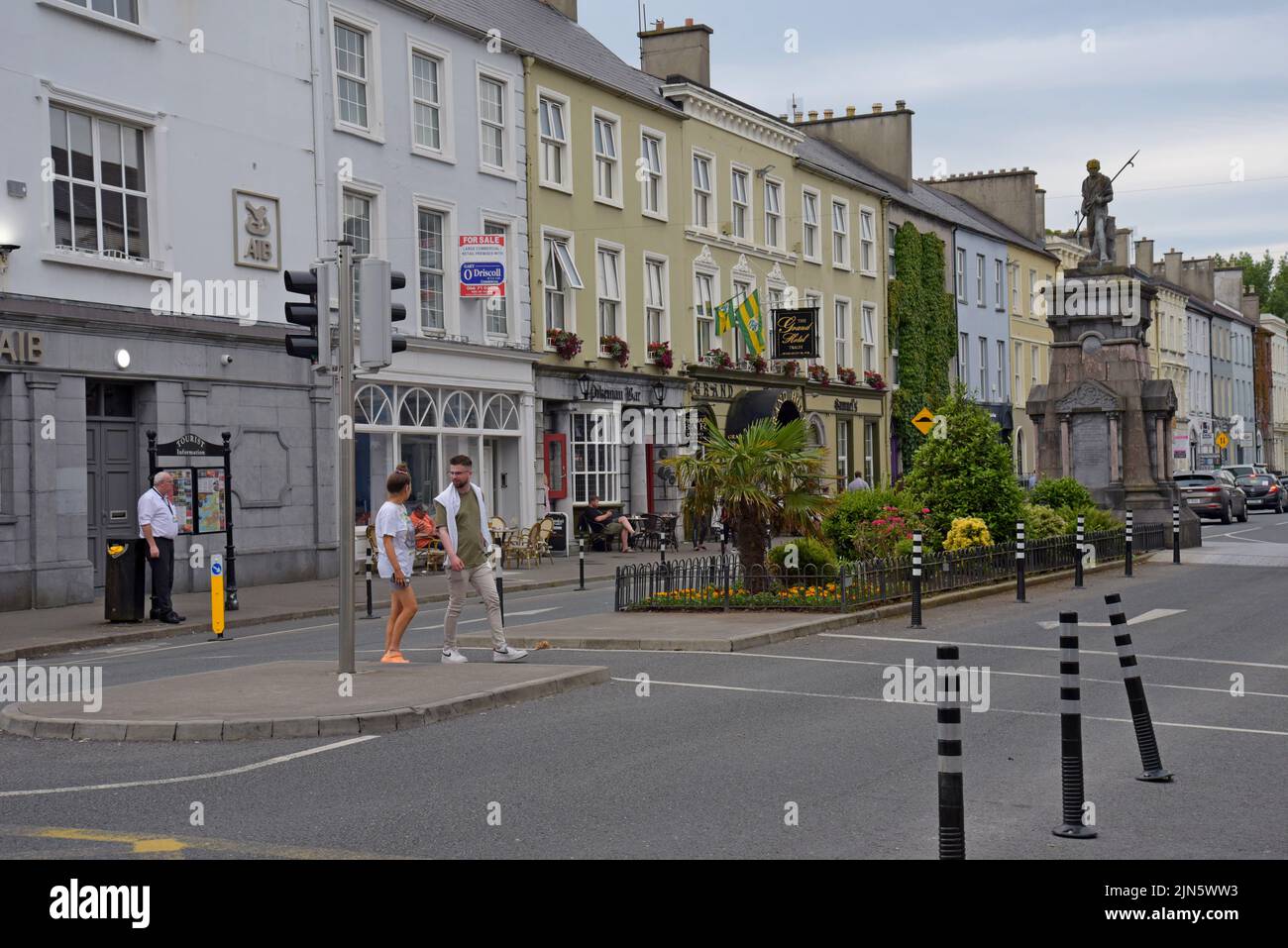 People in the street and sat outside the Grand Hotel, Denny Street ...