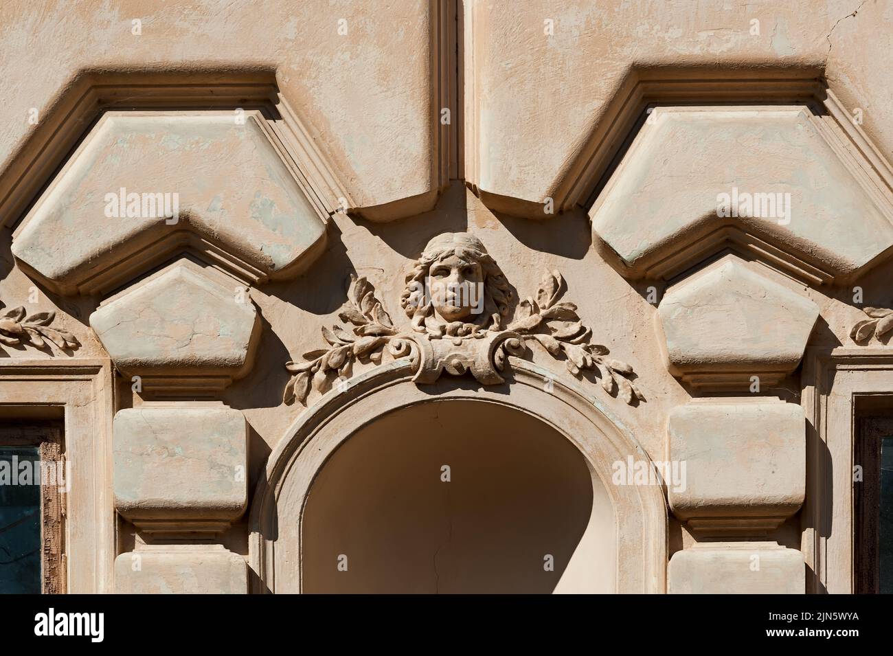 Decorative mascaron on the facade of the Badeni palace in Koropets ...