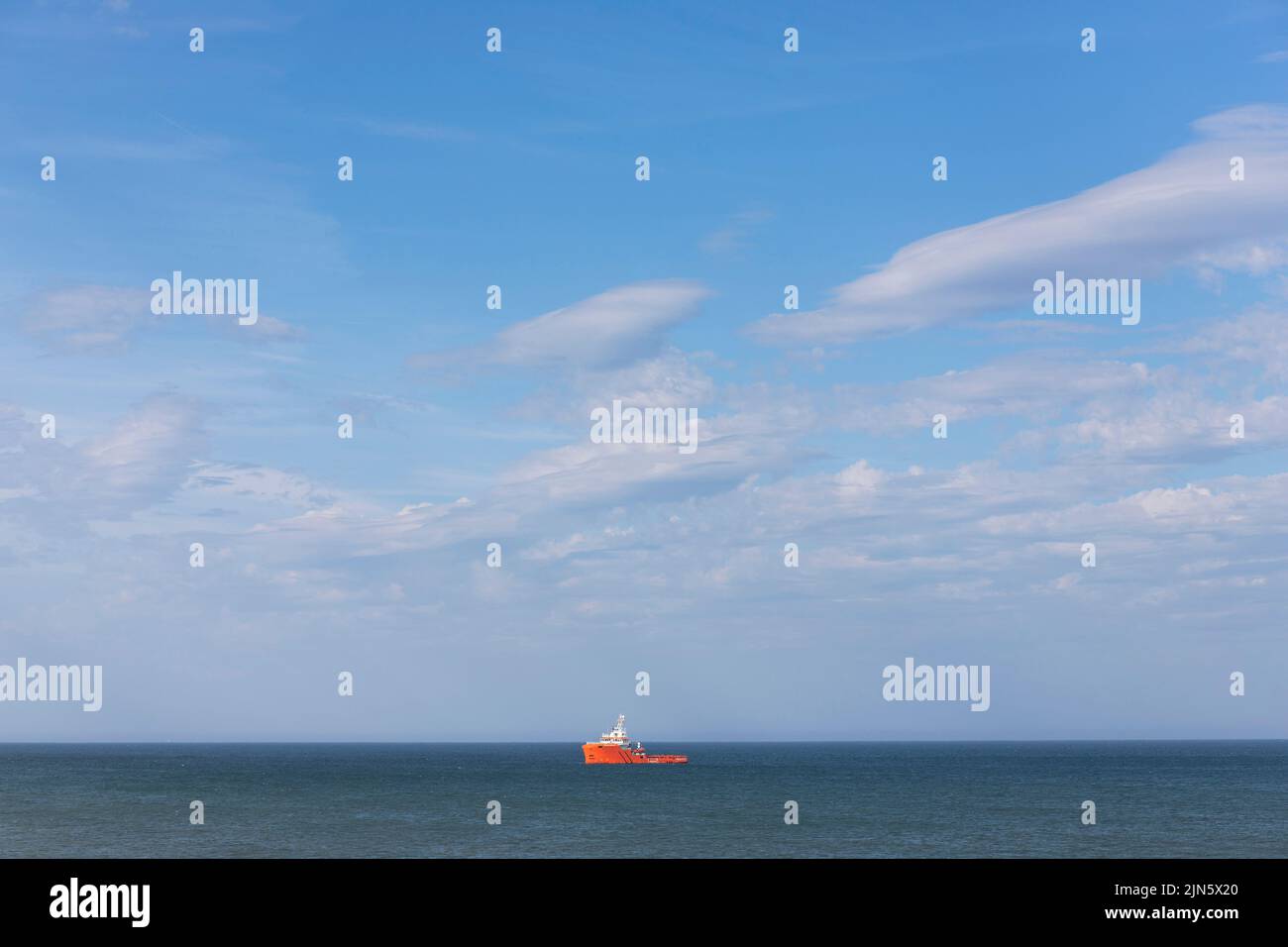 A single orange 'rescue' boat / ship alone on the centre of the horizon ...