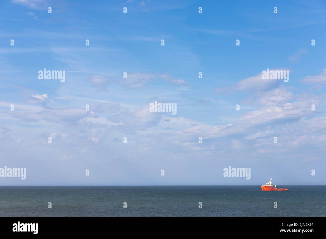 A single orange 'rescue' boat / ship alone on the right of the horizon ...