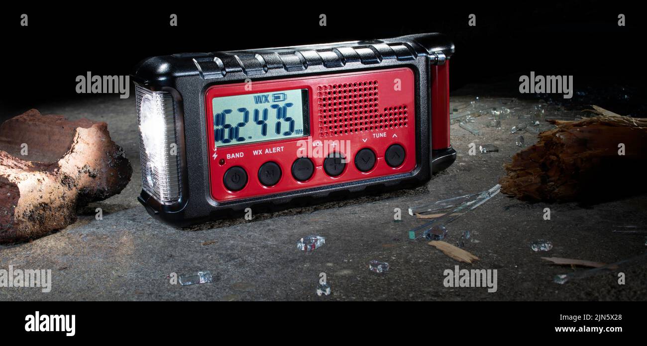 Emergency weather radio with broken glass and a brick Stock Photo - Alamy