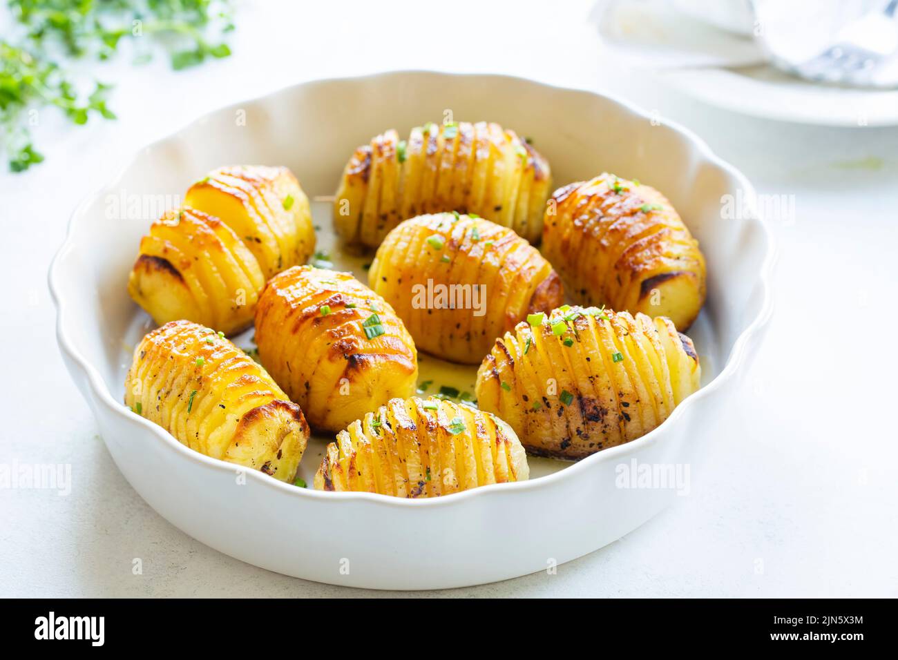 Top view on a traditional Swedish dish Hasselback potatoes with ...