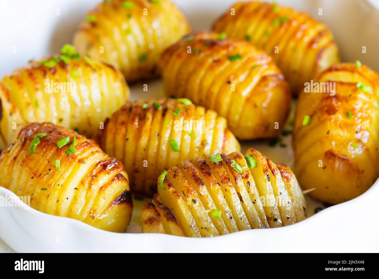 Top view on a traditional Swedish dish Hasselback potatoes with ...