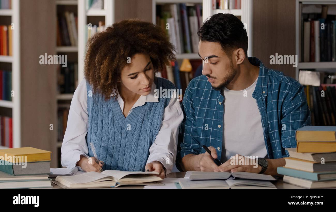 Students do homework in library teamwork working on joint project cute ...