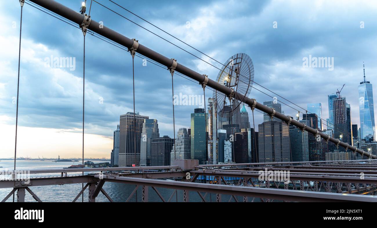 A scenic view of the New York City from the Brooklyn Bridge on a gloomy ...