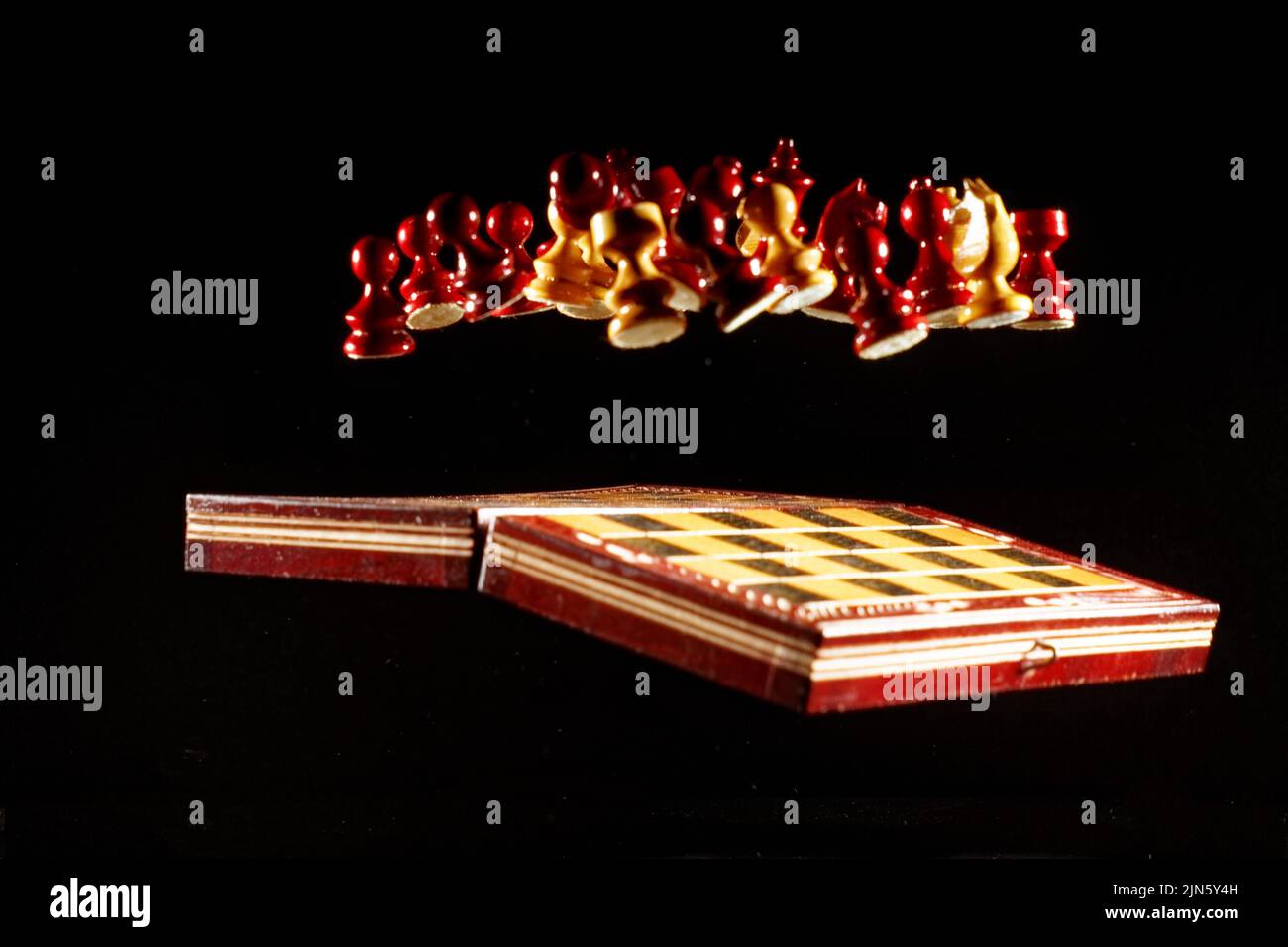 A game of vintage traveling chess set with the figurines flying ...