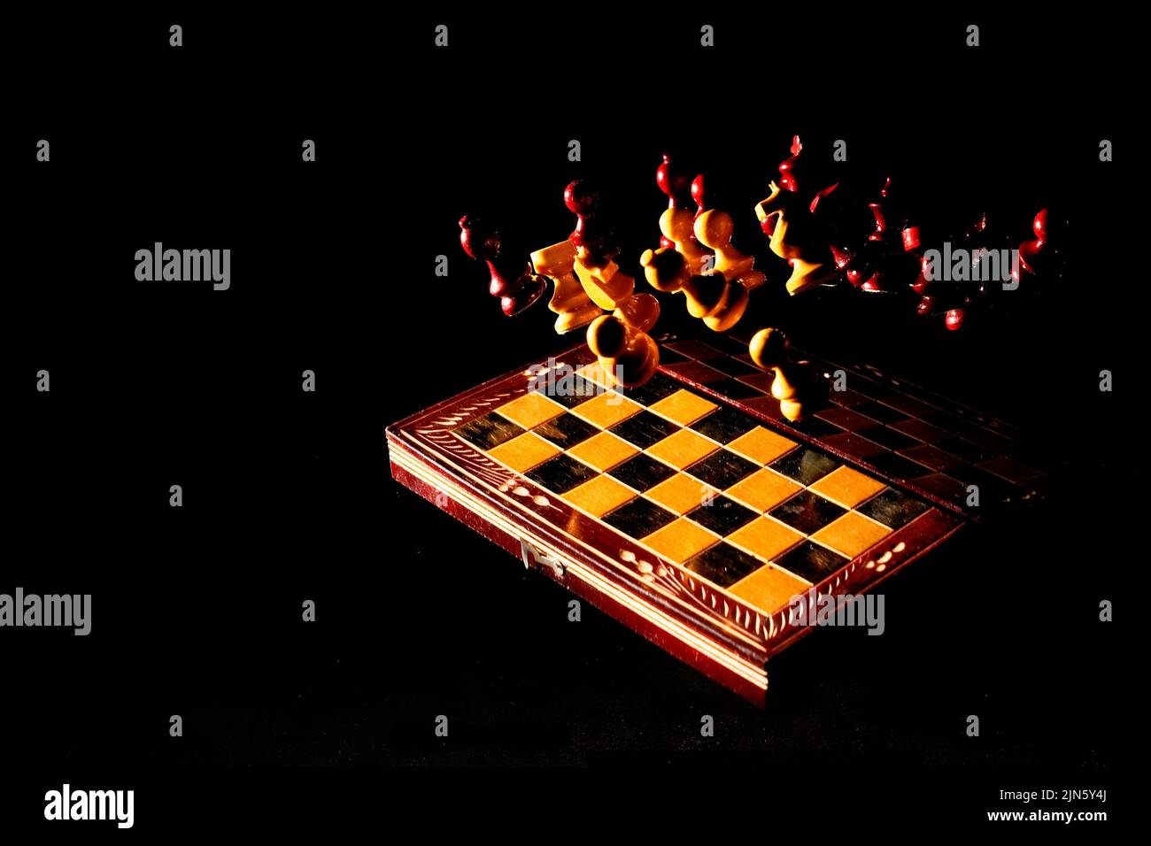 A game of vintage traveling chess set with the figurines flying ...