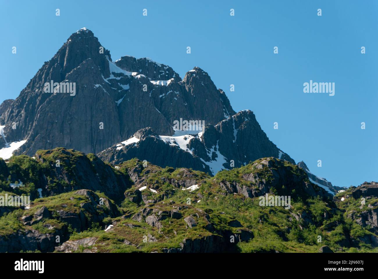 The peaks of mountains against the sky in Trollfjorden, Lofoten islands ...