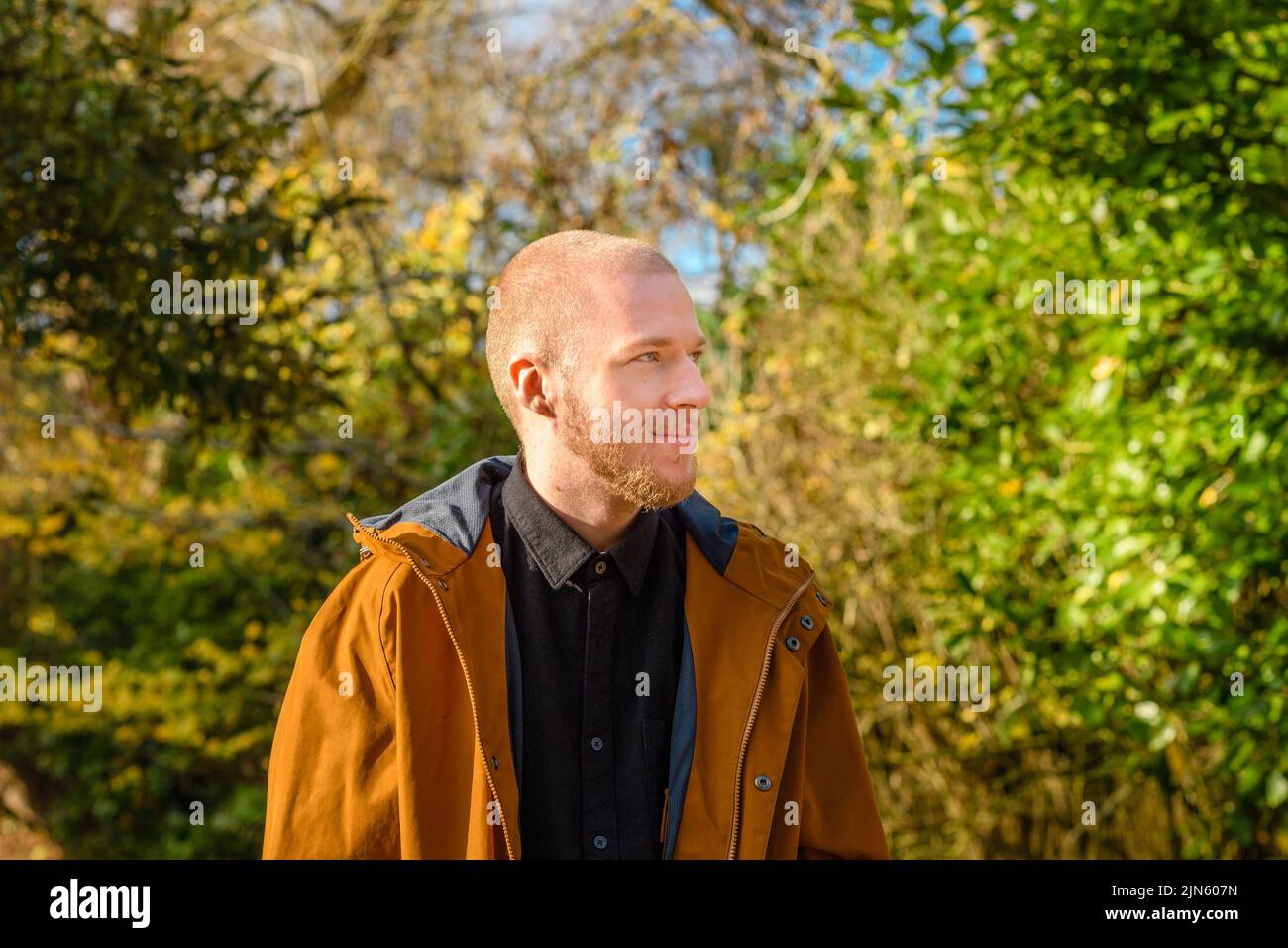 A handsome British guy with blond hair standing in the park Stock Photo ...
