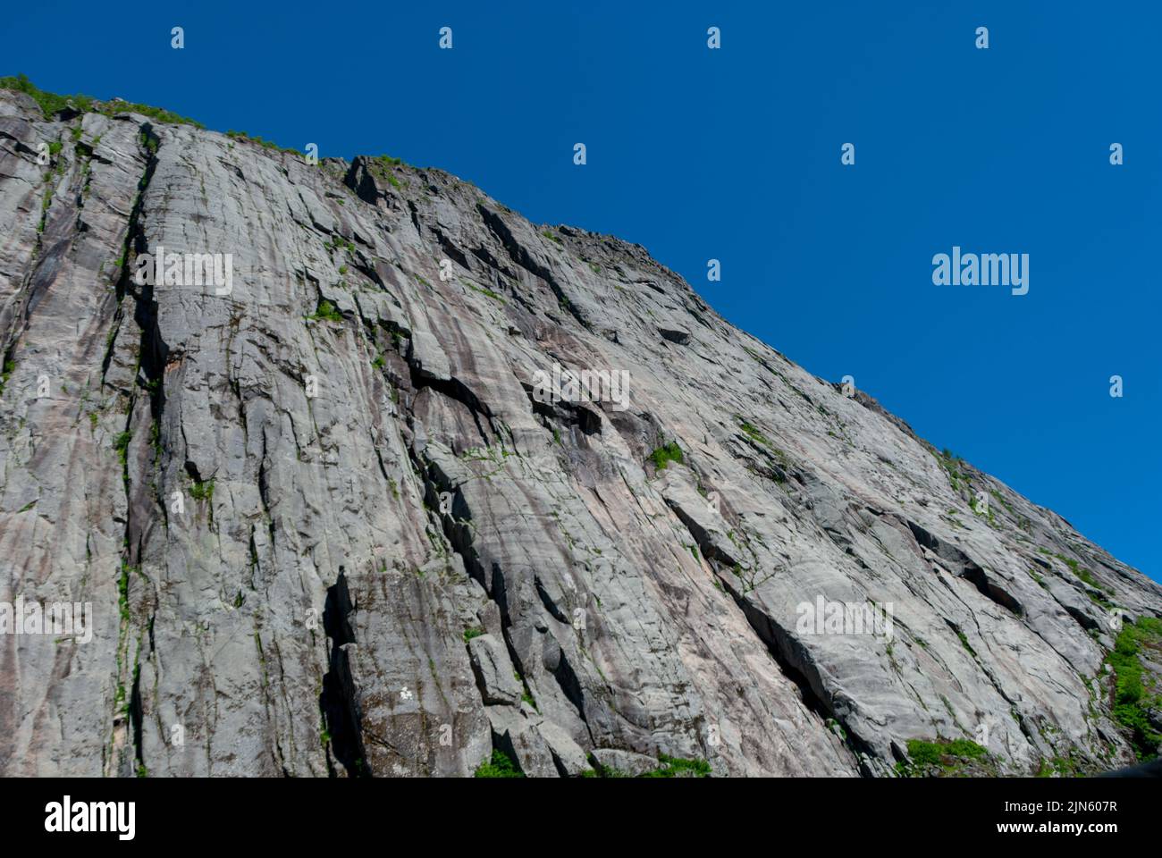 The peaks of mountains against the sky in Trollfjorden, Lofoten islands ...