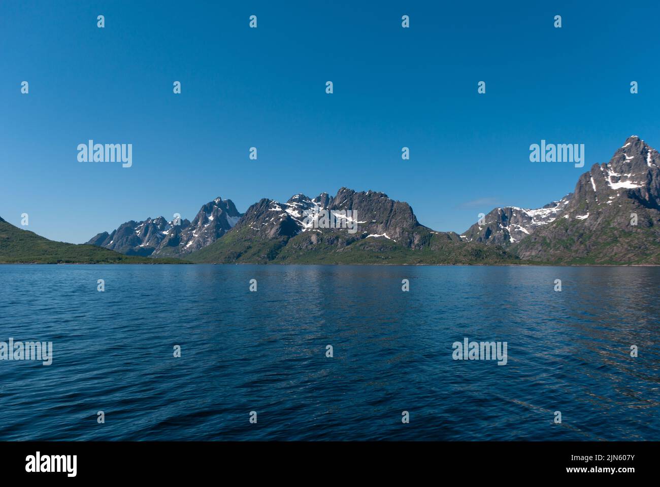 The mountains by a lake against the sky in Trollfjorden, Lofoten ...