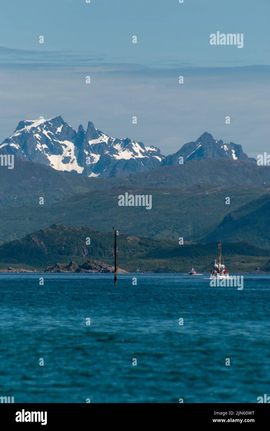The rocky snowcap mountains on the sea shore on Trollfjorden Lofoten ...