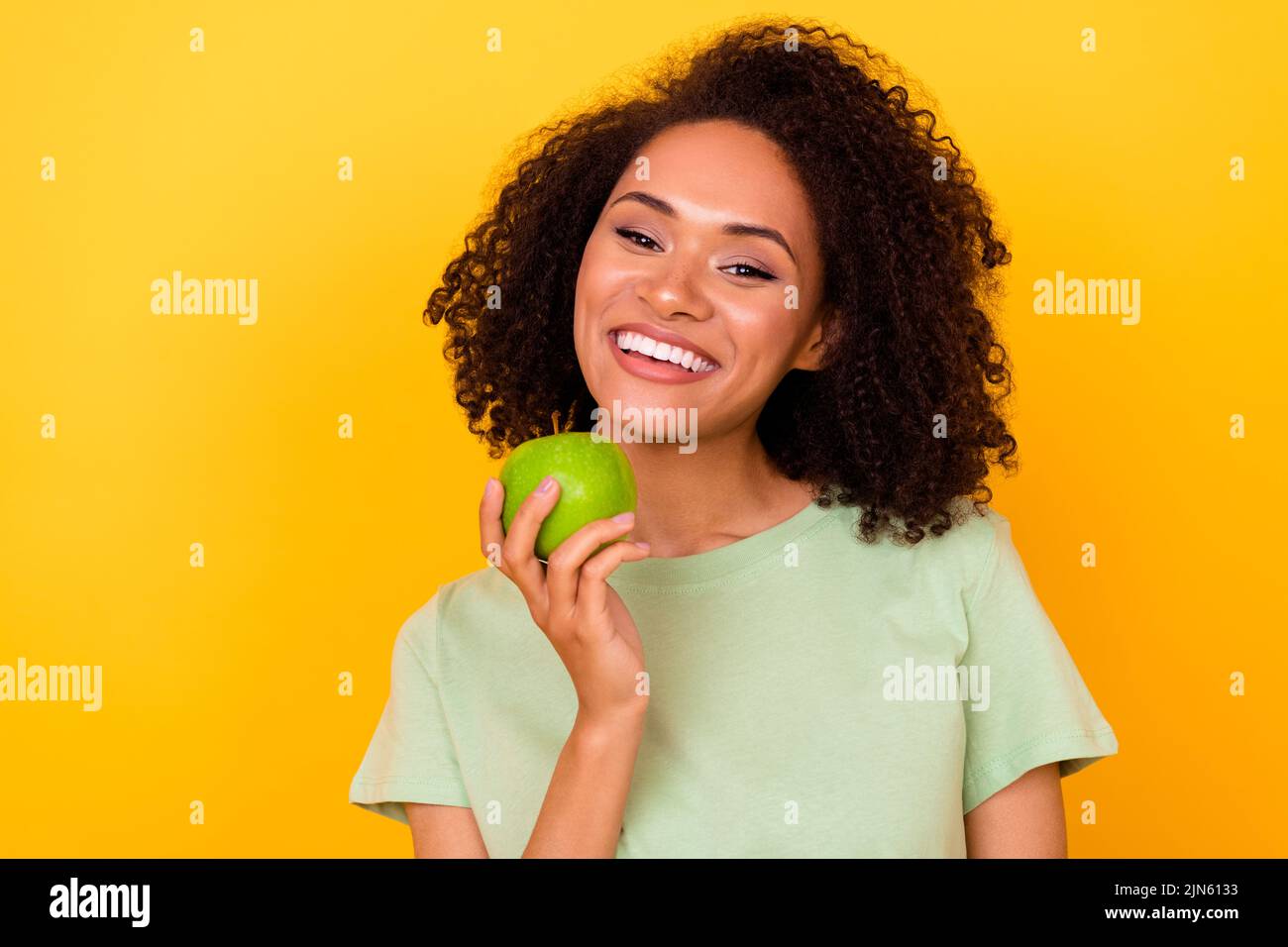 Photo of cheerful positive lady wear green t-shirt eating apple white ...