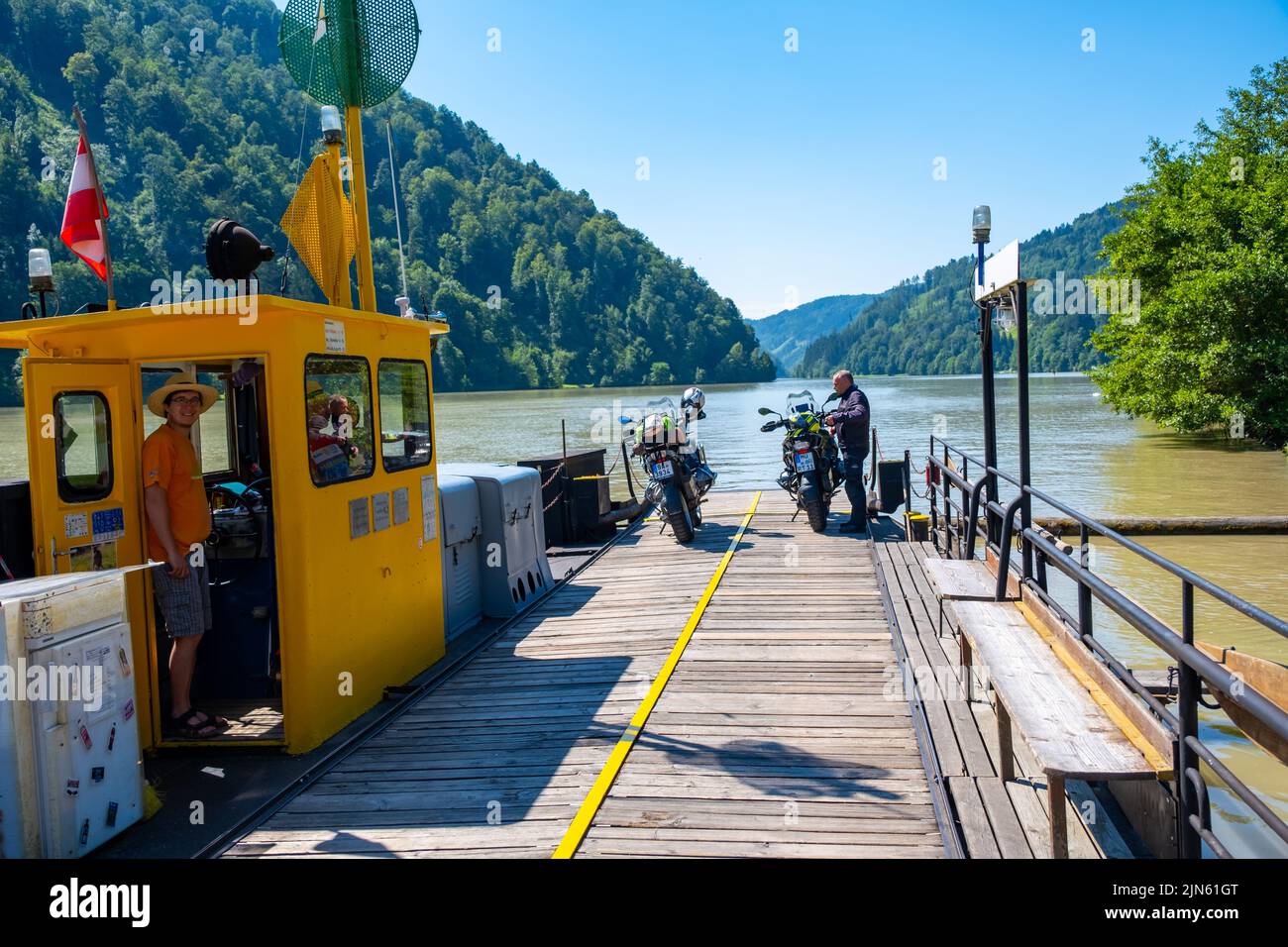 Alps, Austria - July 3, 2022: Small ferry with motorcycles on board ...