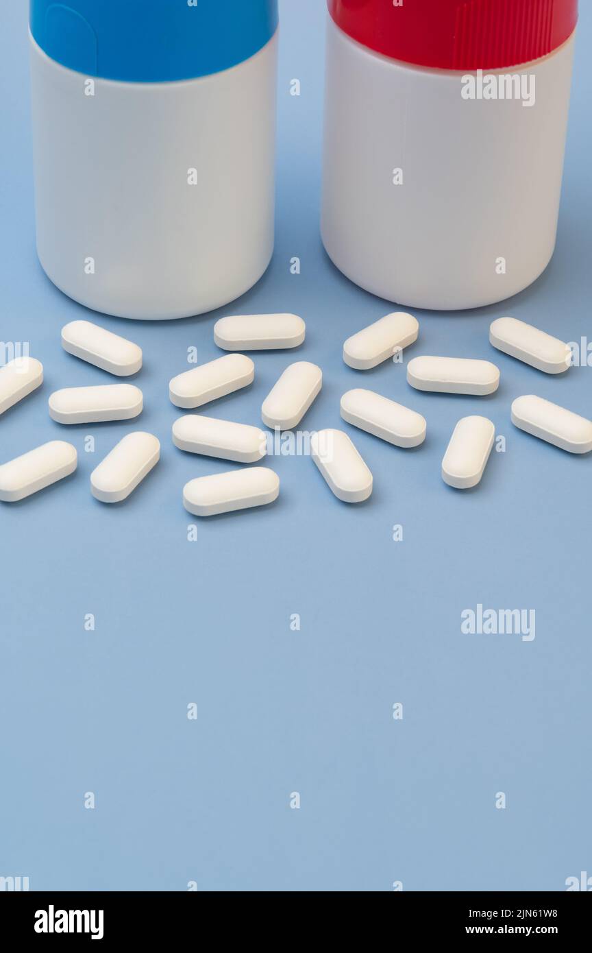 Vitamins tablets supplements Medicine and two containers with Blue and ...