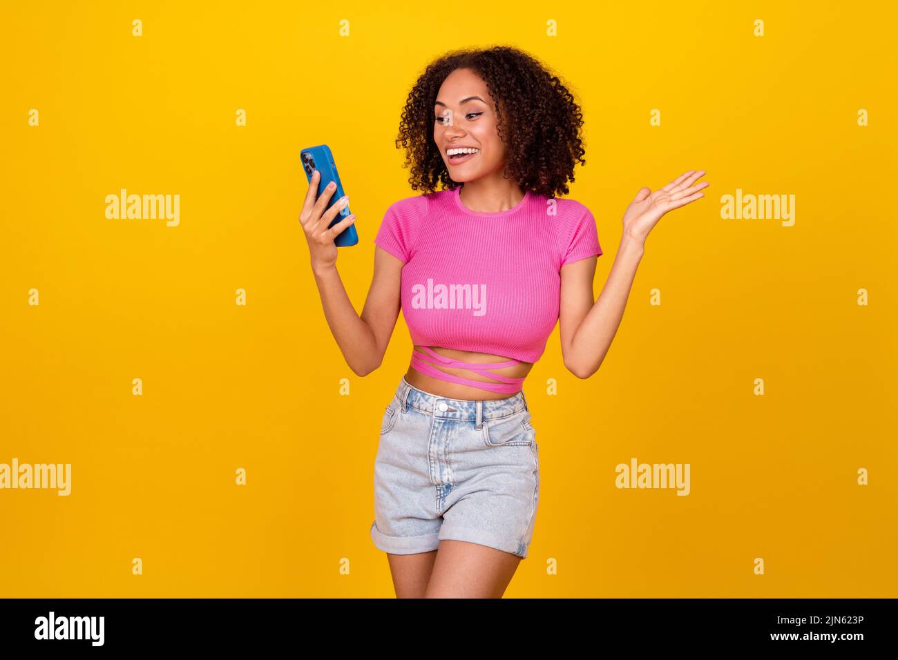 Photo of sweet brunette young lady look telephone wear pink top shorts ...
