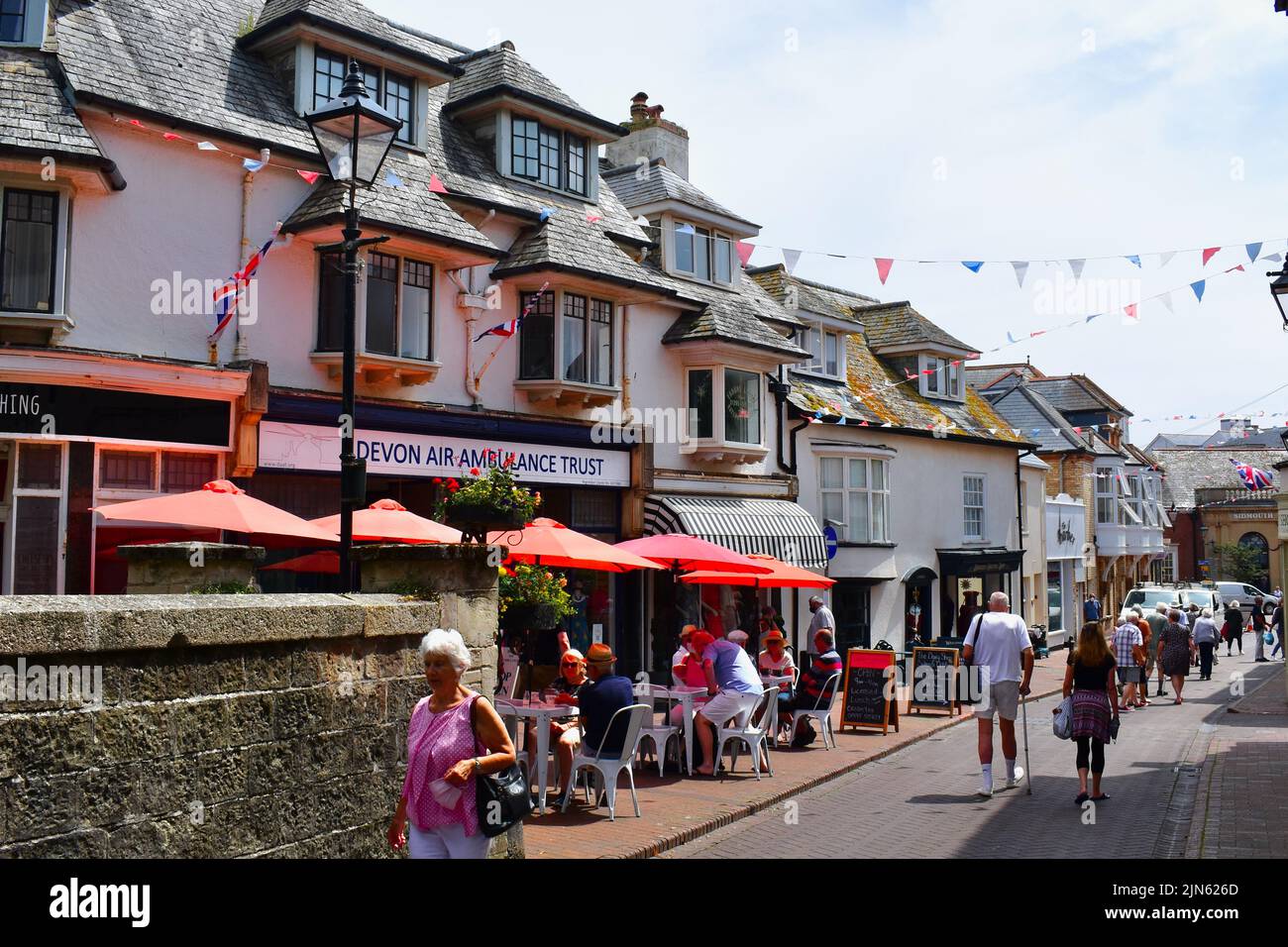A bustling street scene with holidaymakers in the centre of Sidmouth ...