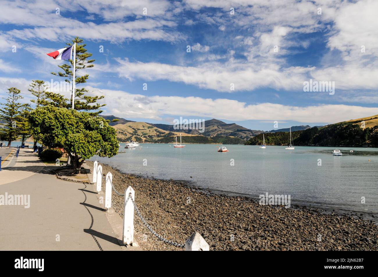The French Tricolour flag at Akaroa bay, a former French settlement in ...
