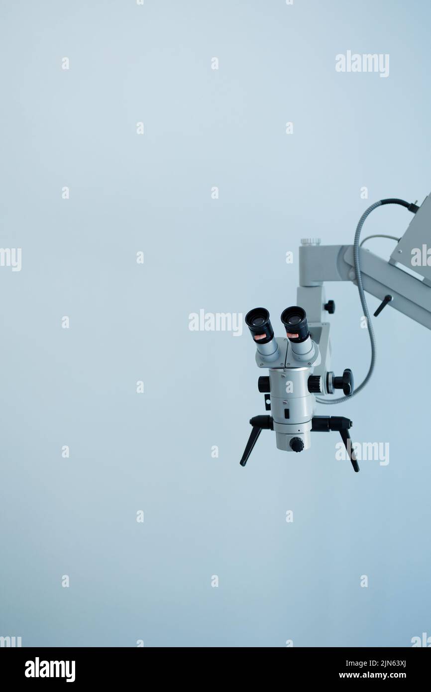 Vertical image of a microscope for dental treatment Stock Photo - Alamy
