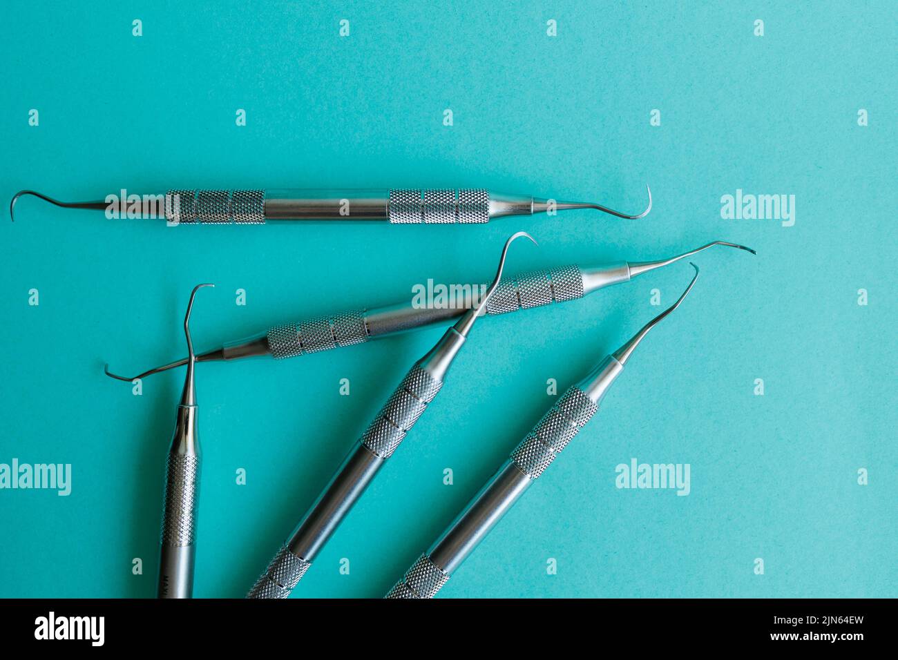 Dental instruments made of medical steel lying on a blue background ...
