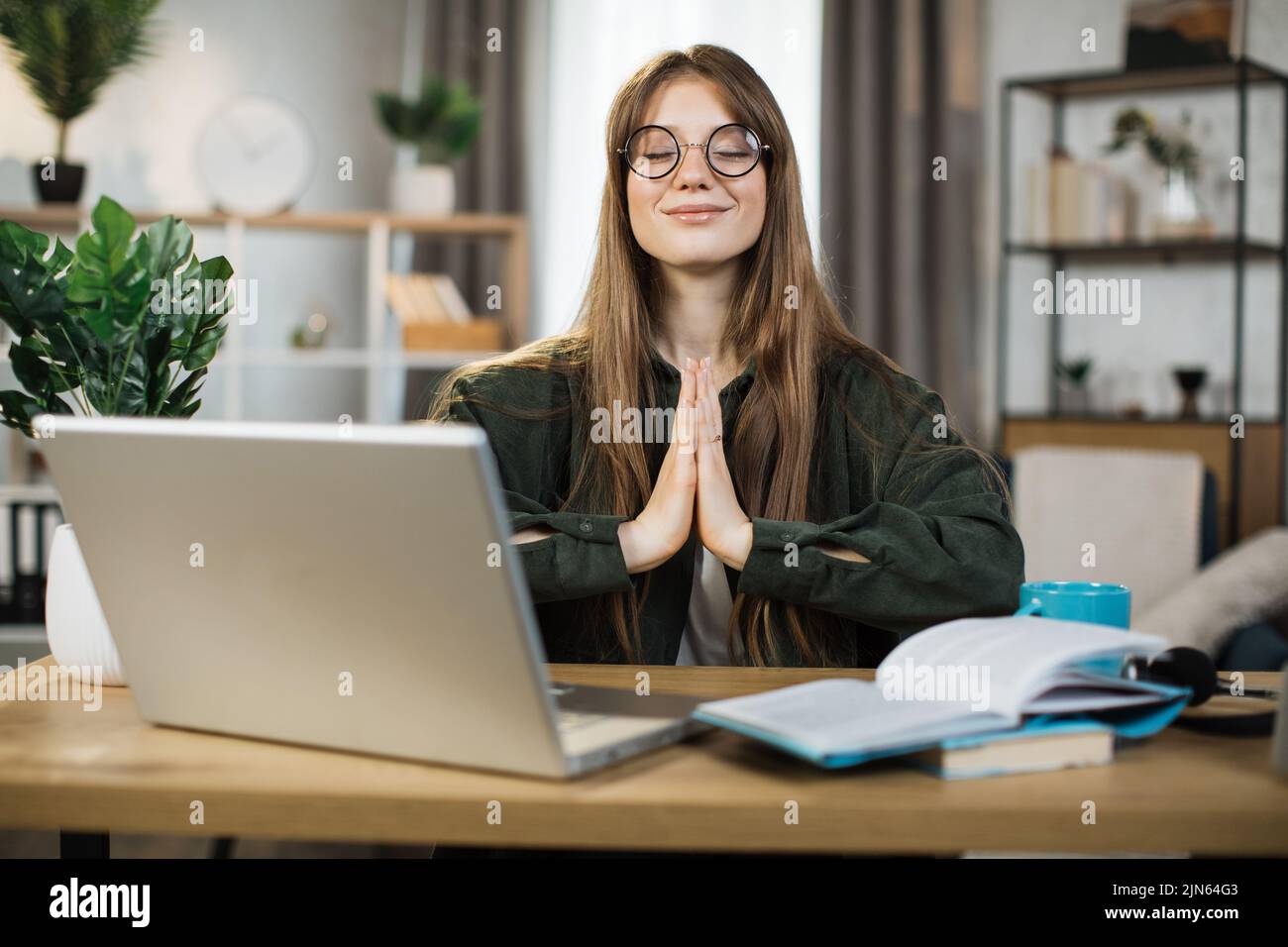 Relaxed caucasian woman in casual wear sitting on workplace with modern ...