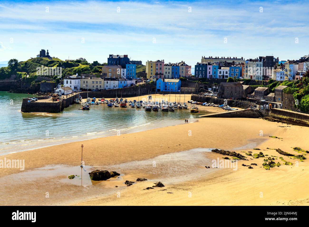 The picturesque sheltered harbour is overlooked by rows of colourful ...
