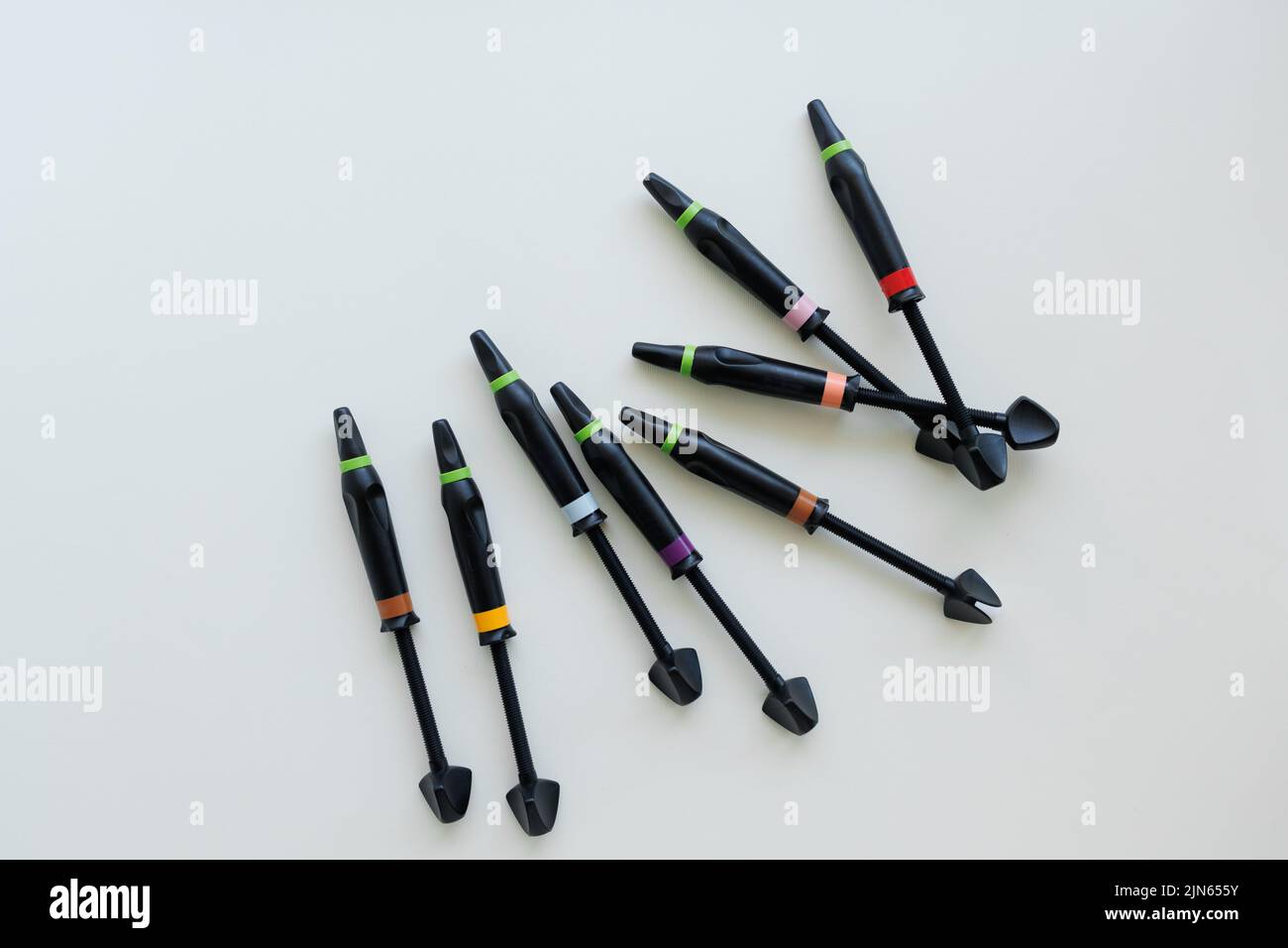 Syringes of dental filling material on white background Stock Photo - Alamy