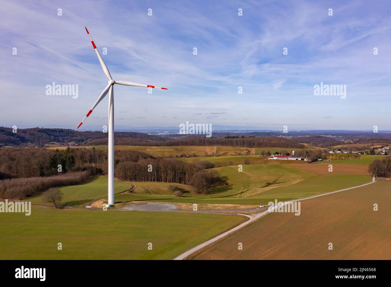 Aerial view of a wind turbine with rotor blades to produce renewable ...