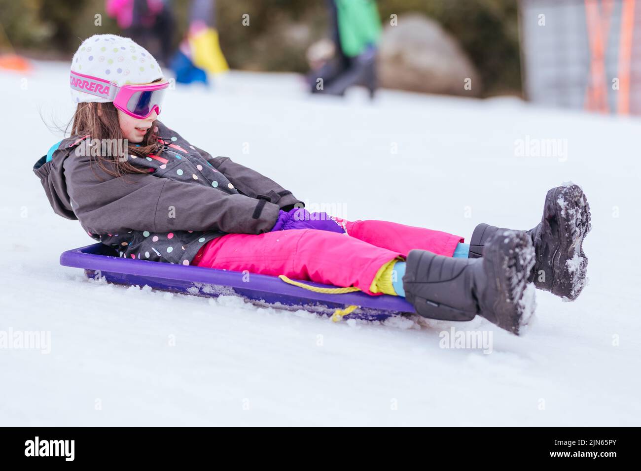 Young Girl Tobogganing in Australia Stock Photo - Alamy