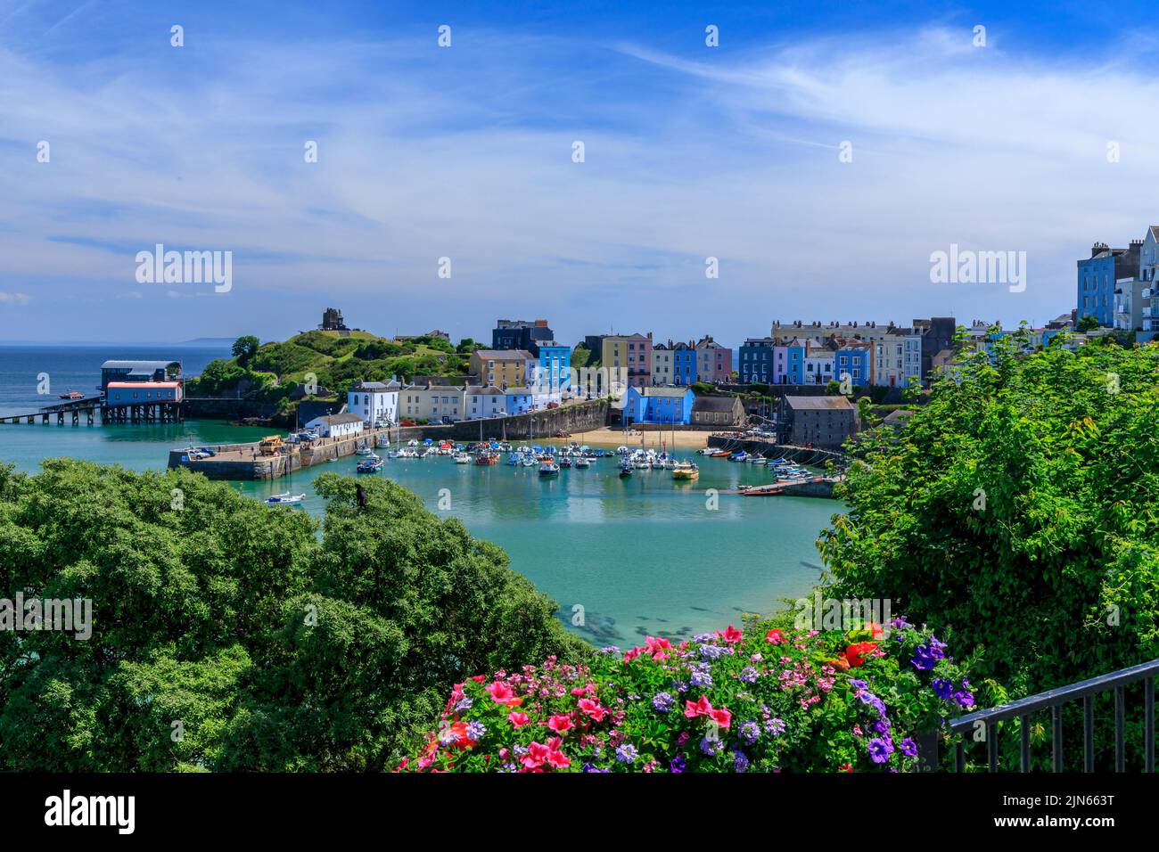 The picturesque sheltered harbour is overlooked by rows of colourful ...