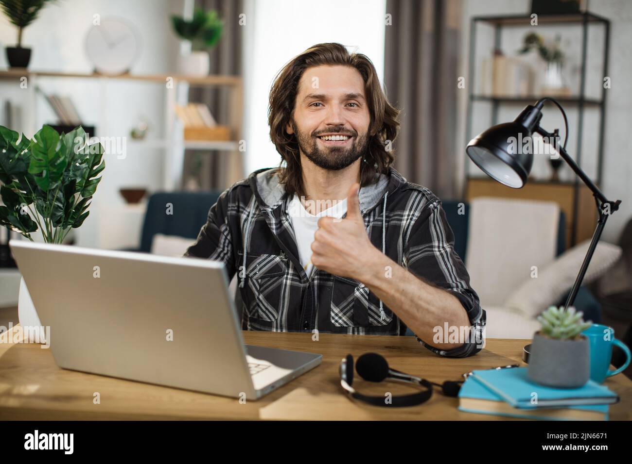 Portrait of attractive male IT specialist typing on keyboard of modern ...