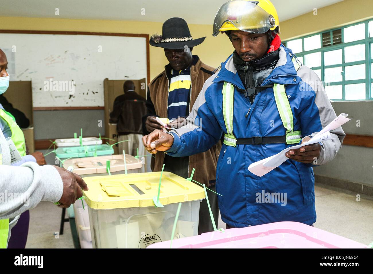 A voter casts his ballot at Nakuru Boys High School Polling Center ...
