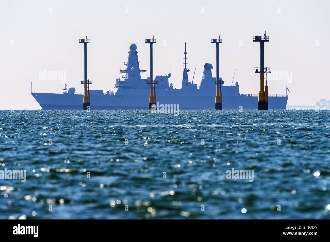 The Type 45 destroyer HMS Duncan passing the aircraft carrier ...