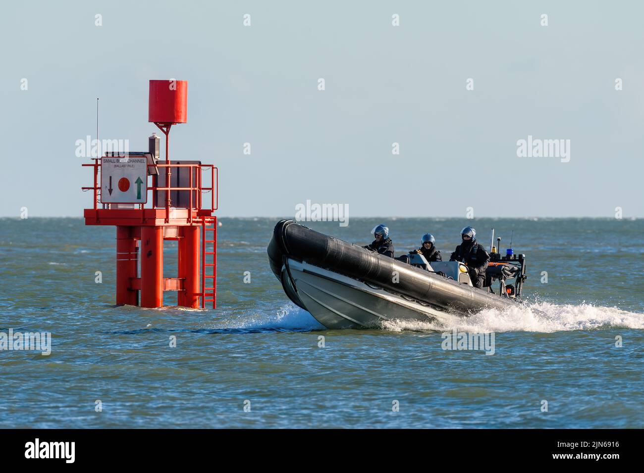 A Police RIB passing the Ballast Pile navigation mark in Portsmouth ...