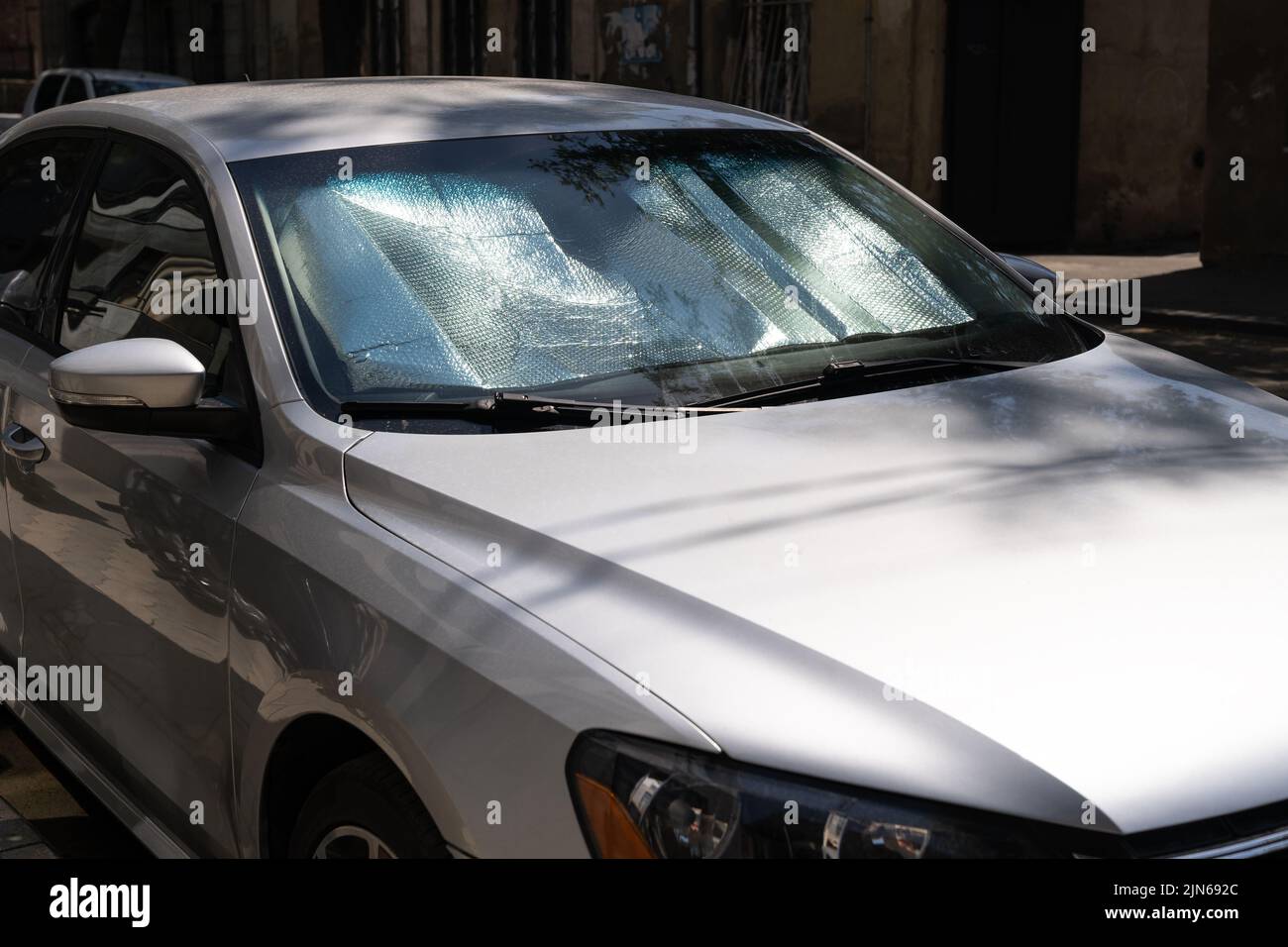 Protective reflective surface under windshield of car on hot day ...