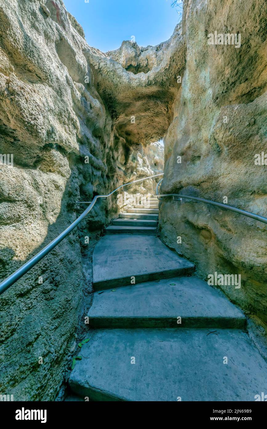 Narrow pathway with concrete steps in between the rock walls in San ...
