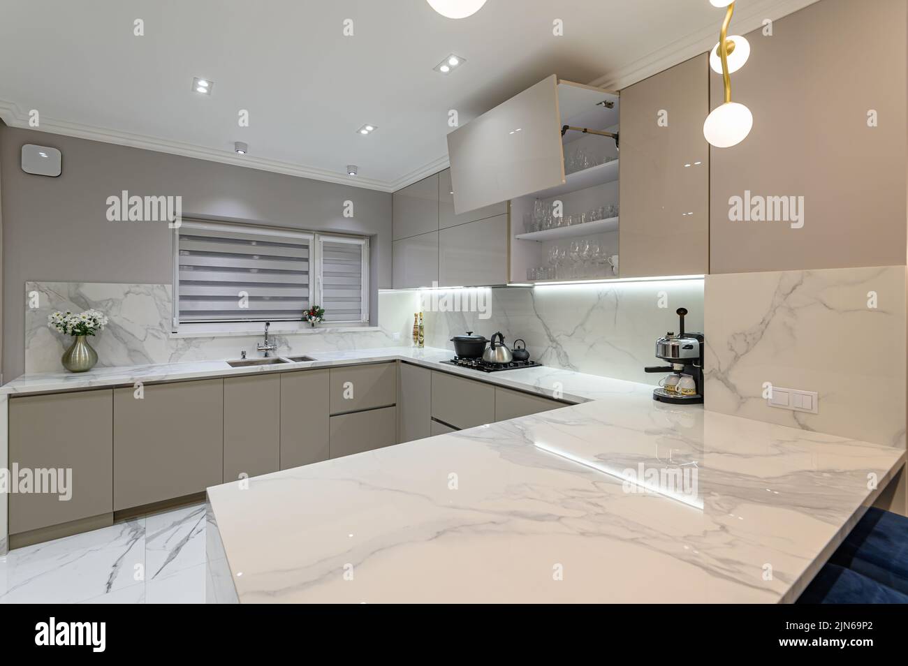 Luxury white modern marble kitchen in studio space Stock Photo - Alamy