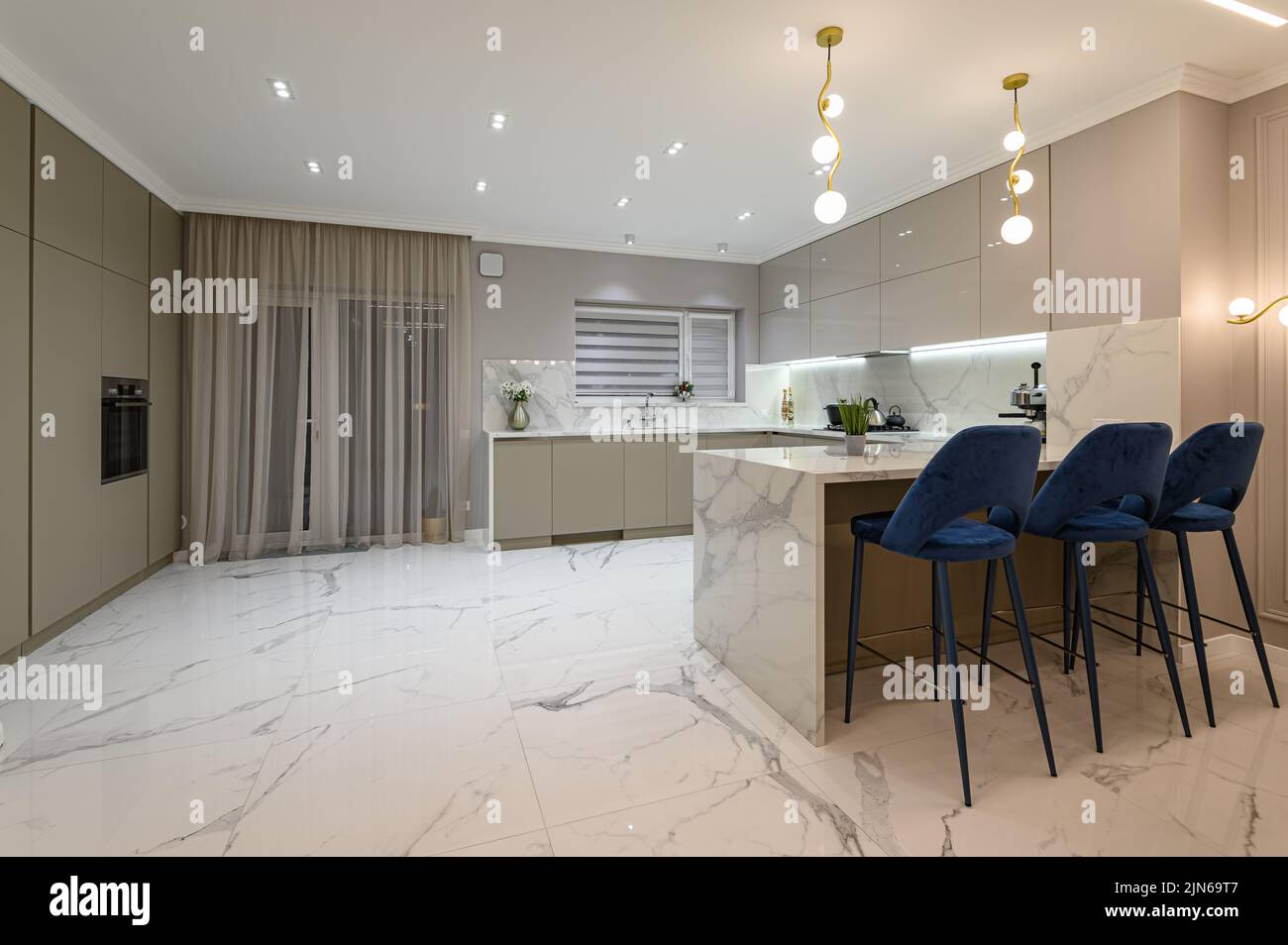 Luxury white modern marble kitchen in studio space Stock Photo - Alamy