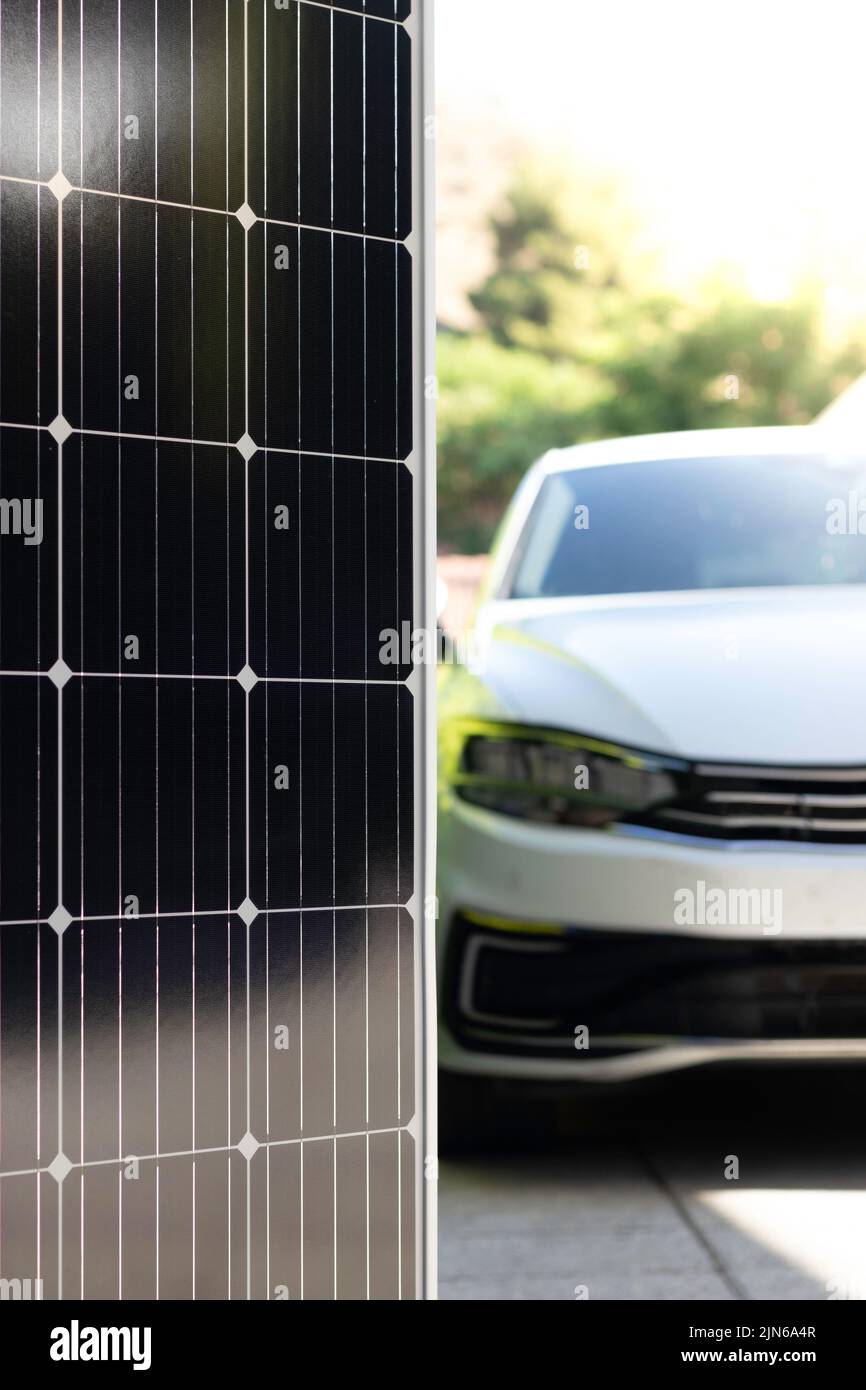 Vertical view of blurred modern white electric car powered with solar ...