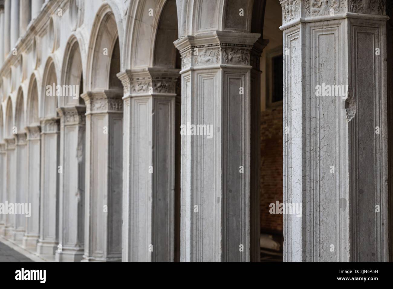 A repetitive architecture of Venetian Gothic columns in muted day light ...