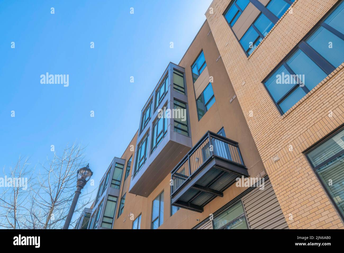 Low angle view of a low-rise residential building with reflective ...